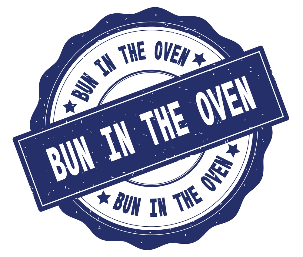 BUN IN THE OVEN text, written on blue round badge. - Smart Pain Solutions